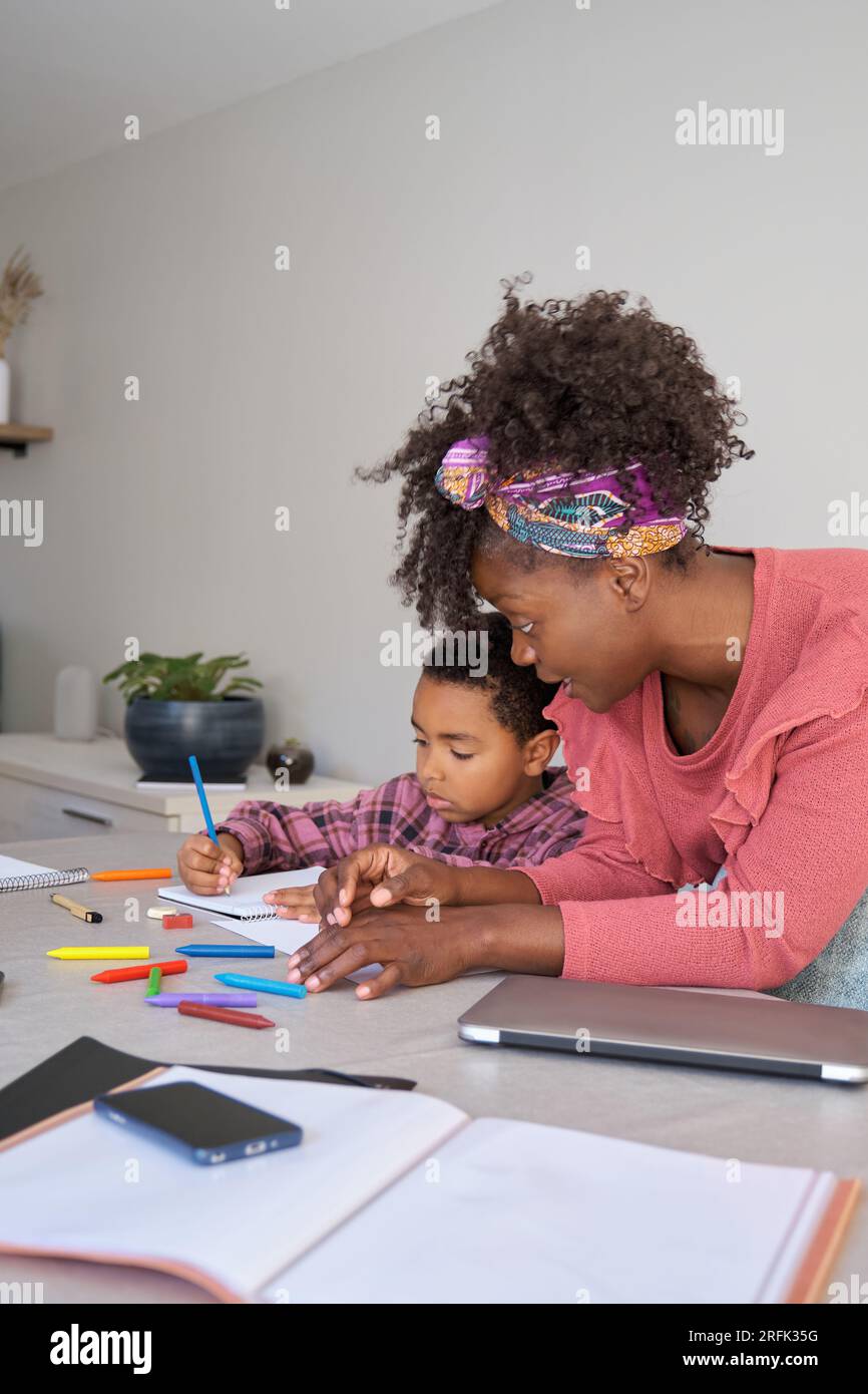 African mother helping her son with homework Stock Photo - Alamy