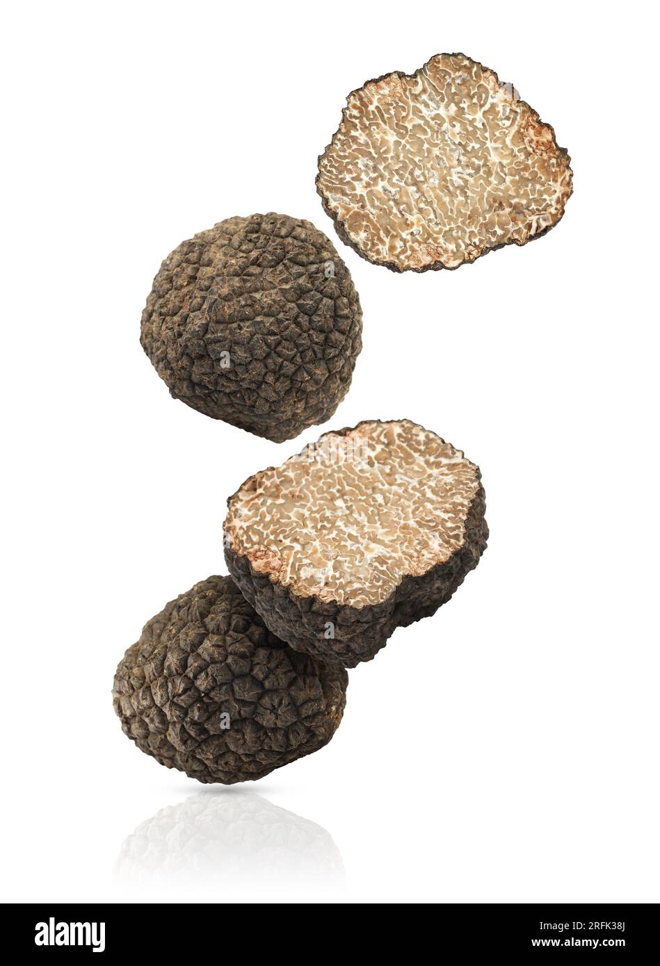 Cut and whole truffles falling on white background Stock Photo - Alamy