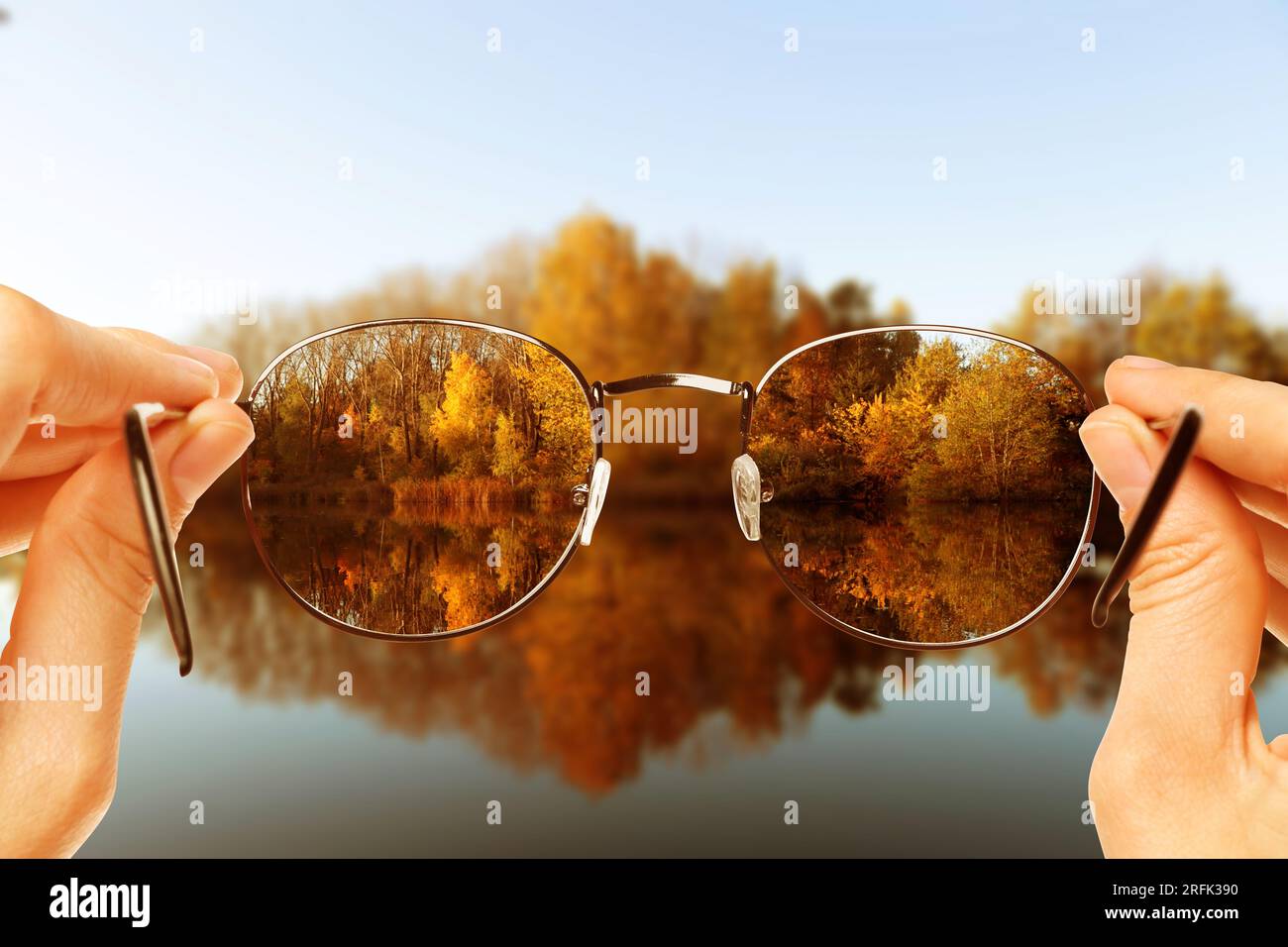 Vision correction. Woman looking through glasses and seeing landscape ...