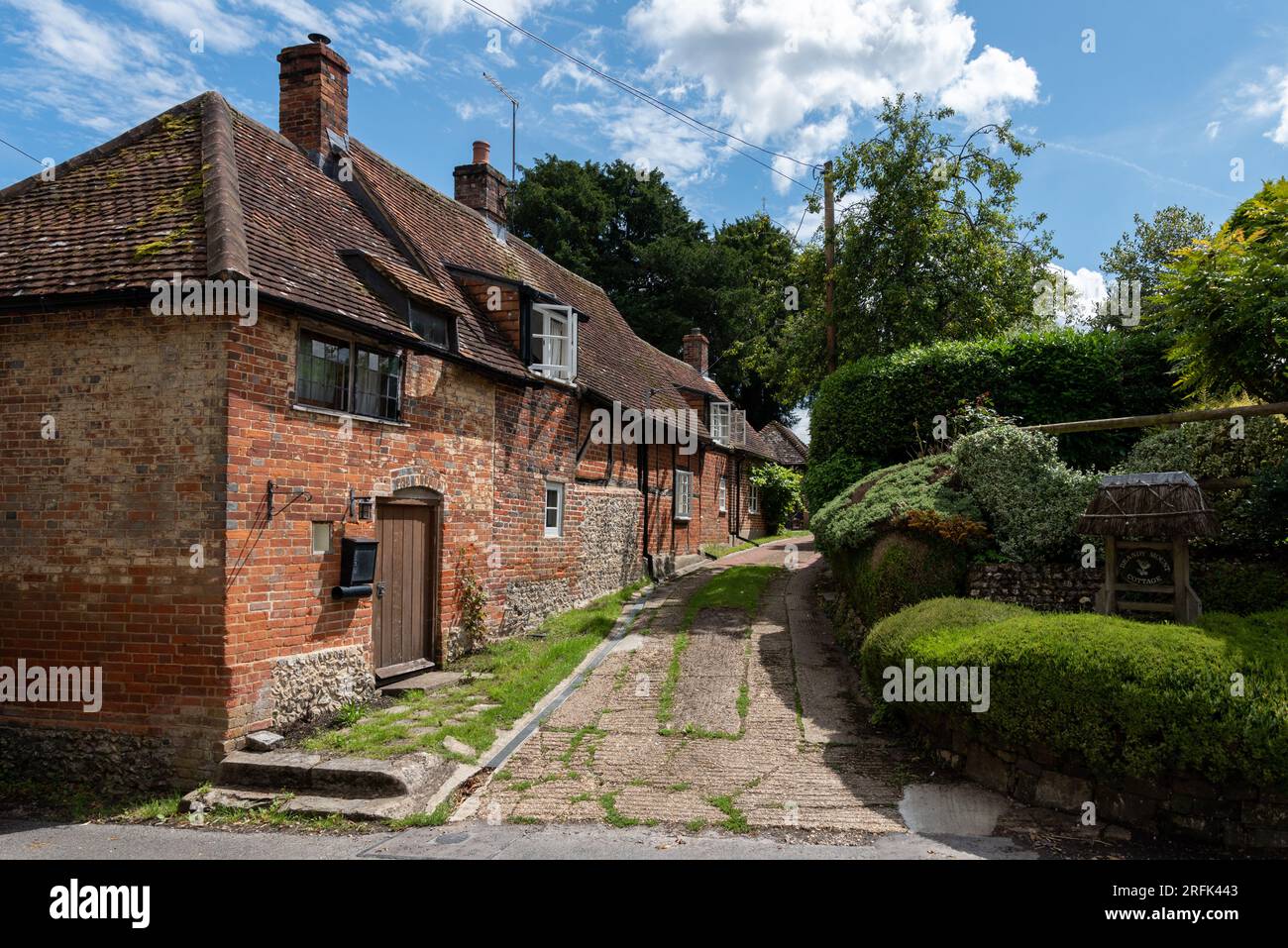 Brick houses and a small lane in the English countryside village of ...