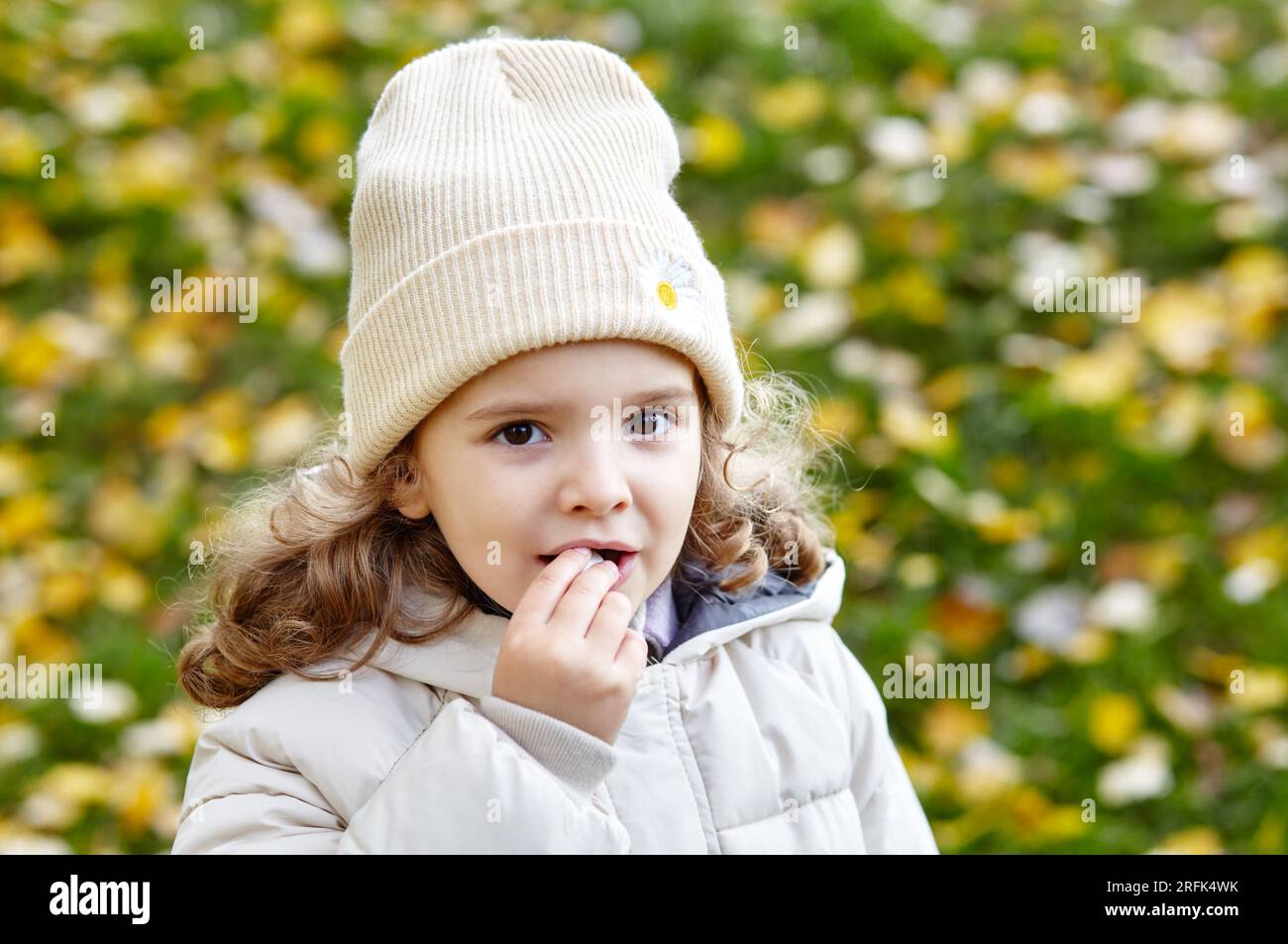 Baby girl are walking in the autumn city park. Little child having fun ...
