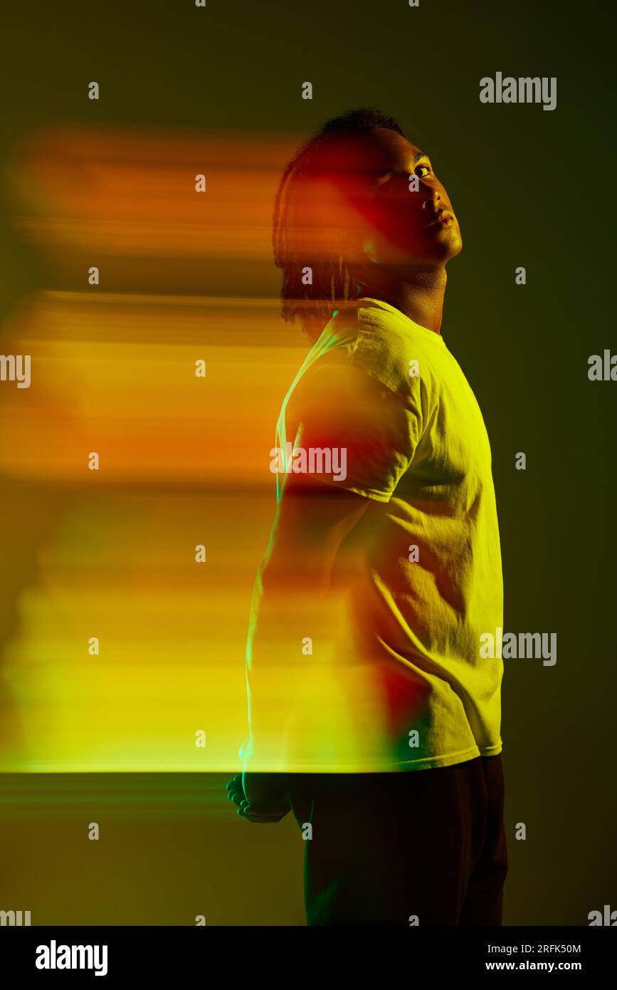 Portrait of handsome young guy posing against gradient green background ...