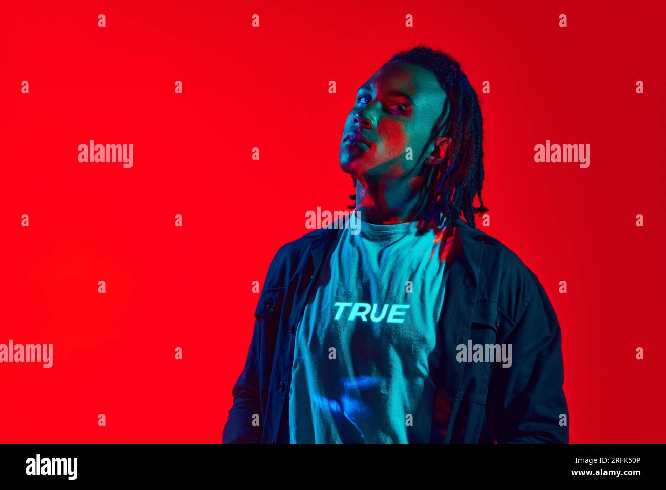 Truth. Handsome young man with neon filter reflection on body posing ...