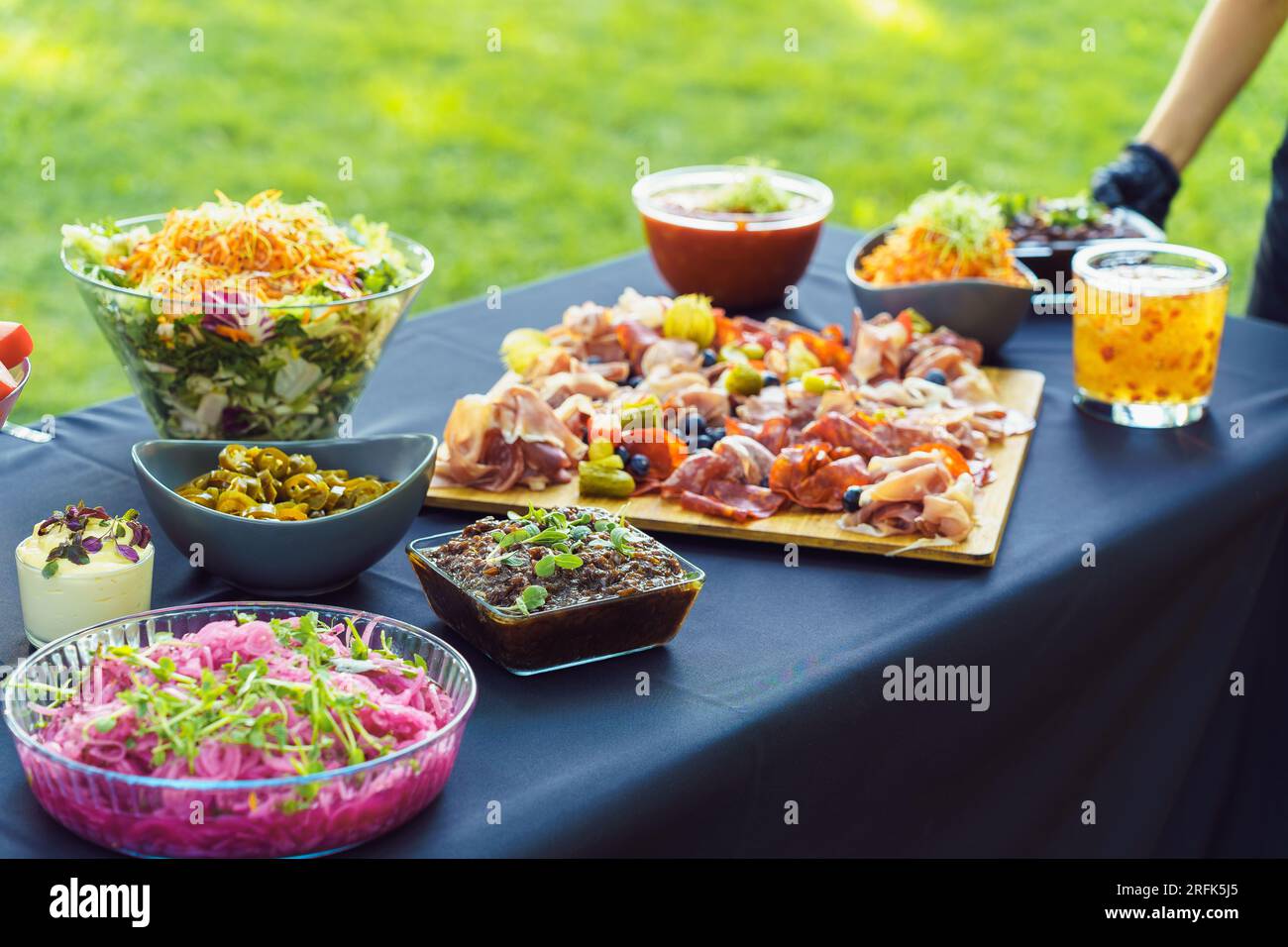 Waiter puts food on buffet hi-res stock photography and images - Alamy