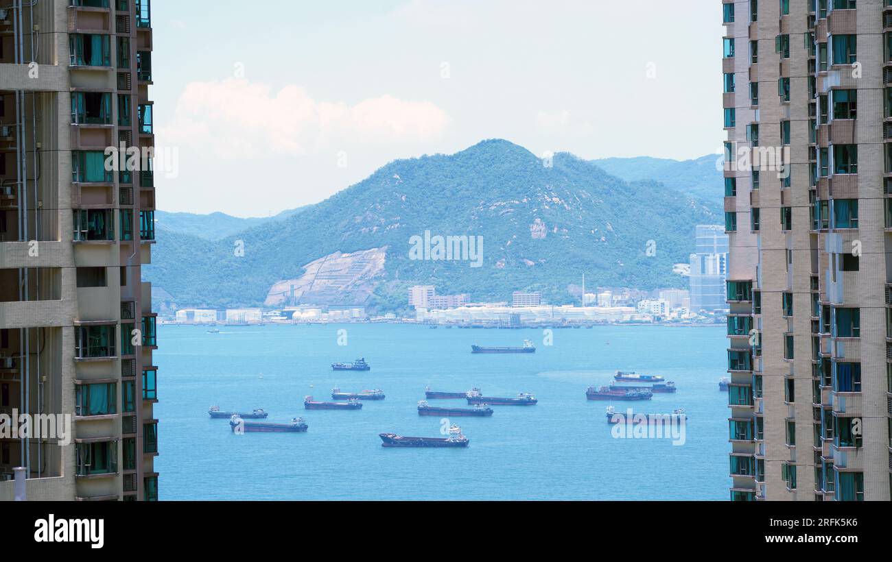 the empty container ships park near the Kwai Tsing port between ...