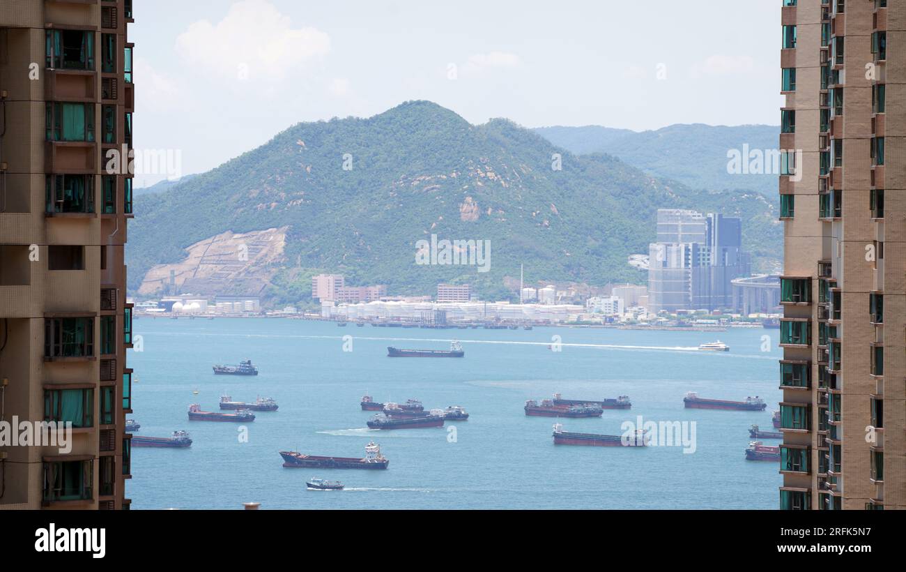 the empty container ships park near the Kwai Tsing port between ...