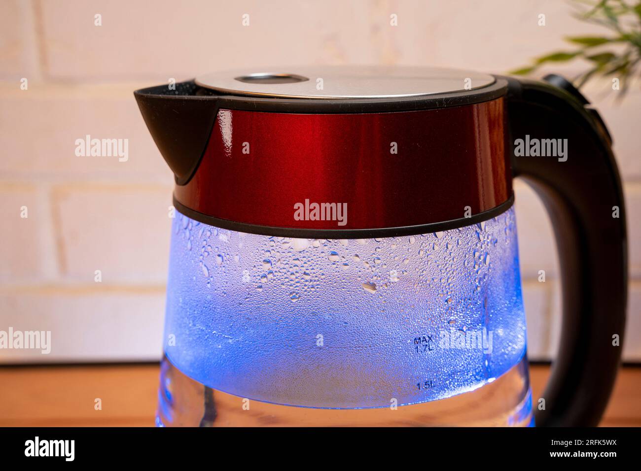 modern electric kettle with boiling water and condensate on glass walls ...