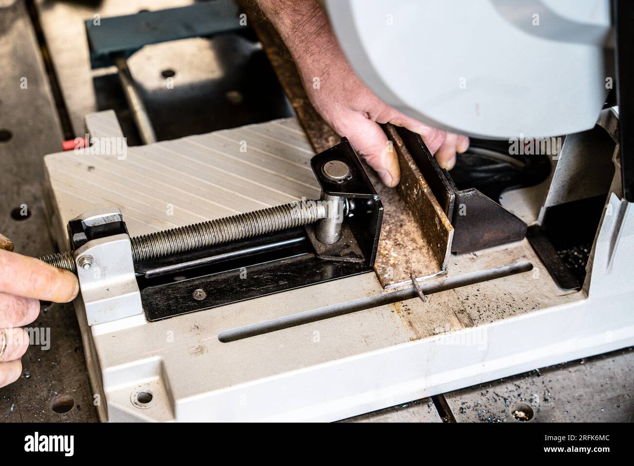 metal saw with tool cutting disc makes a cut. work in home workshop ...
