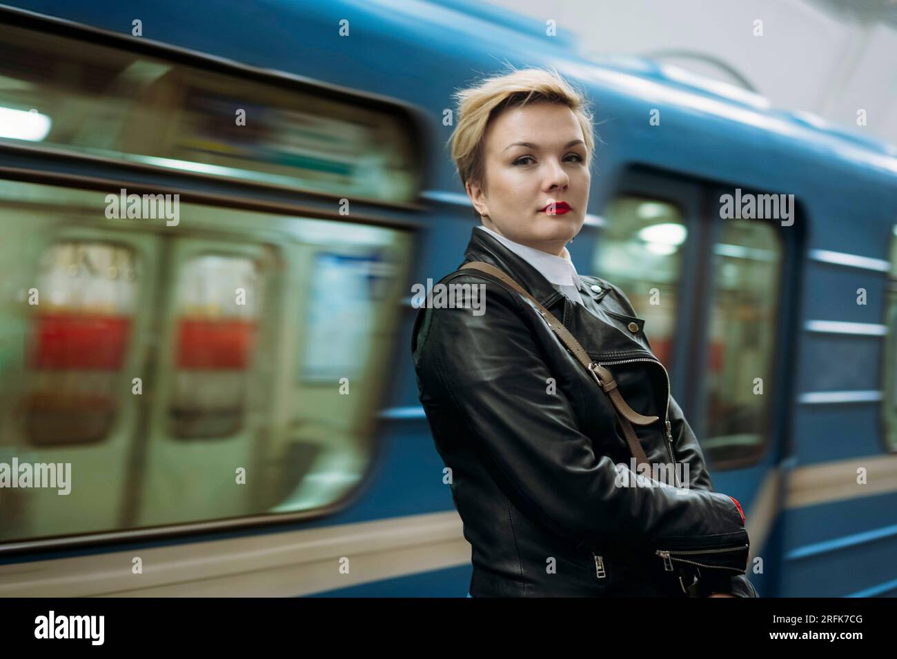 short haired caucasian woman wearing leather jacket on platform of ...