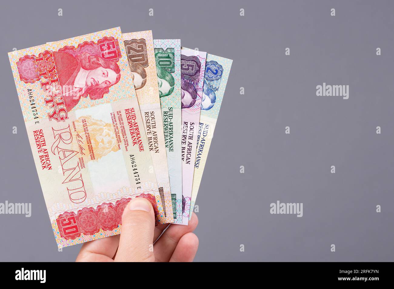 Old South African money - rand in the hand on a gray background Stock ...