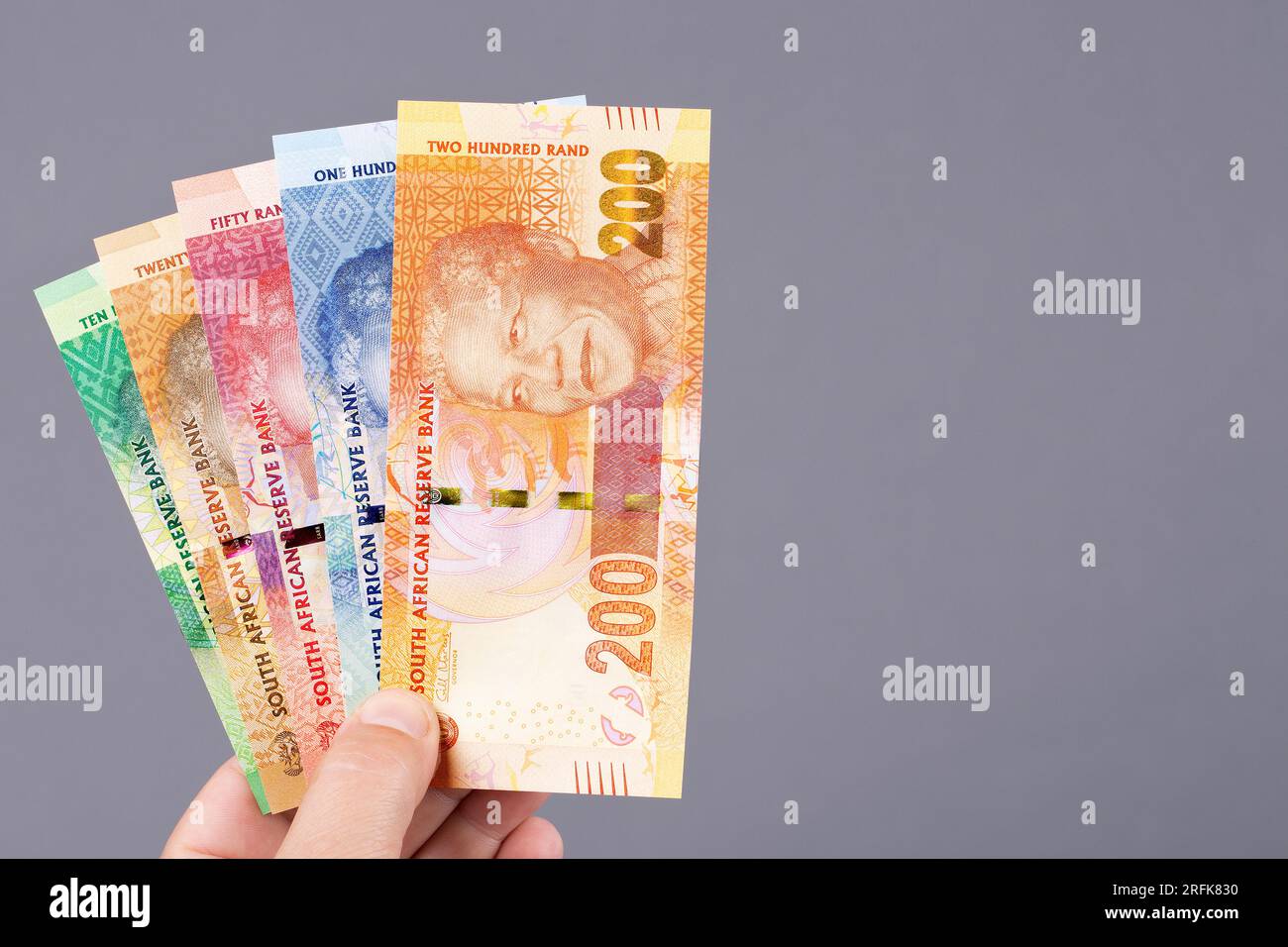 South African money - rand in the hand on a gray background Stock Photo ...