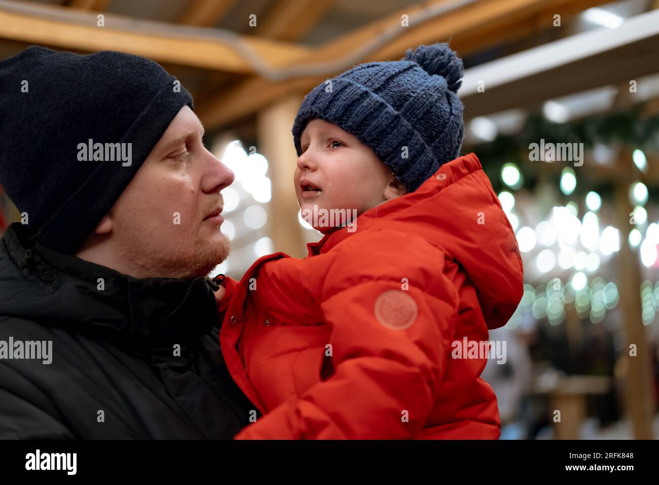 caucasian man, father of little daughter calming crying child. Family ...