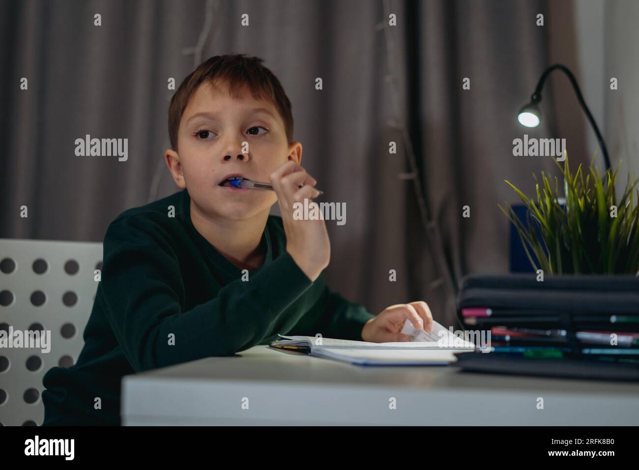 Boy biting pen hi-res stock photography and images - Alamy