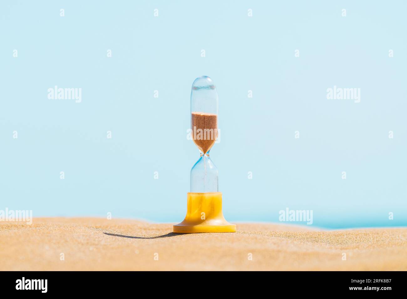 Sand running through an old hourglass measuring passing time and ...