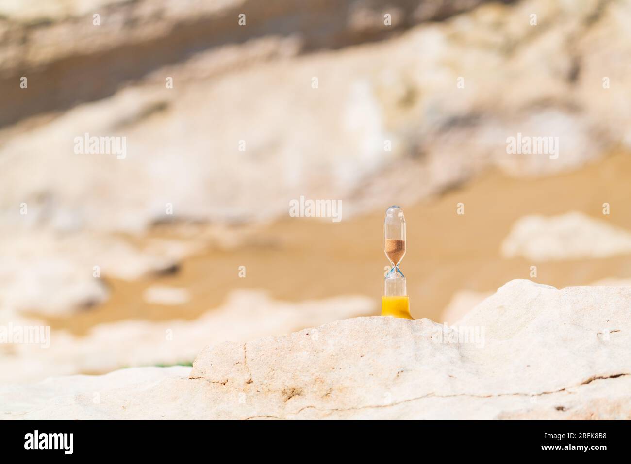 Sand running through an old hourglass measuring passing time and ...