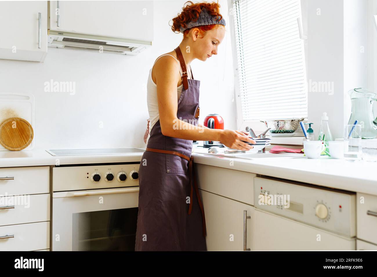 Cleaning washing dishes in home kitchen Stock Photo - Alamy