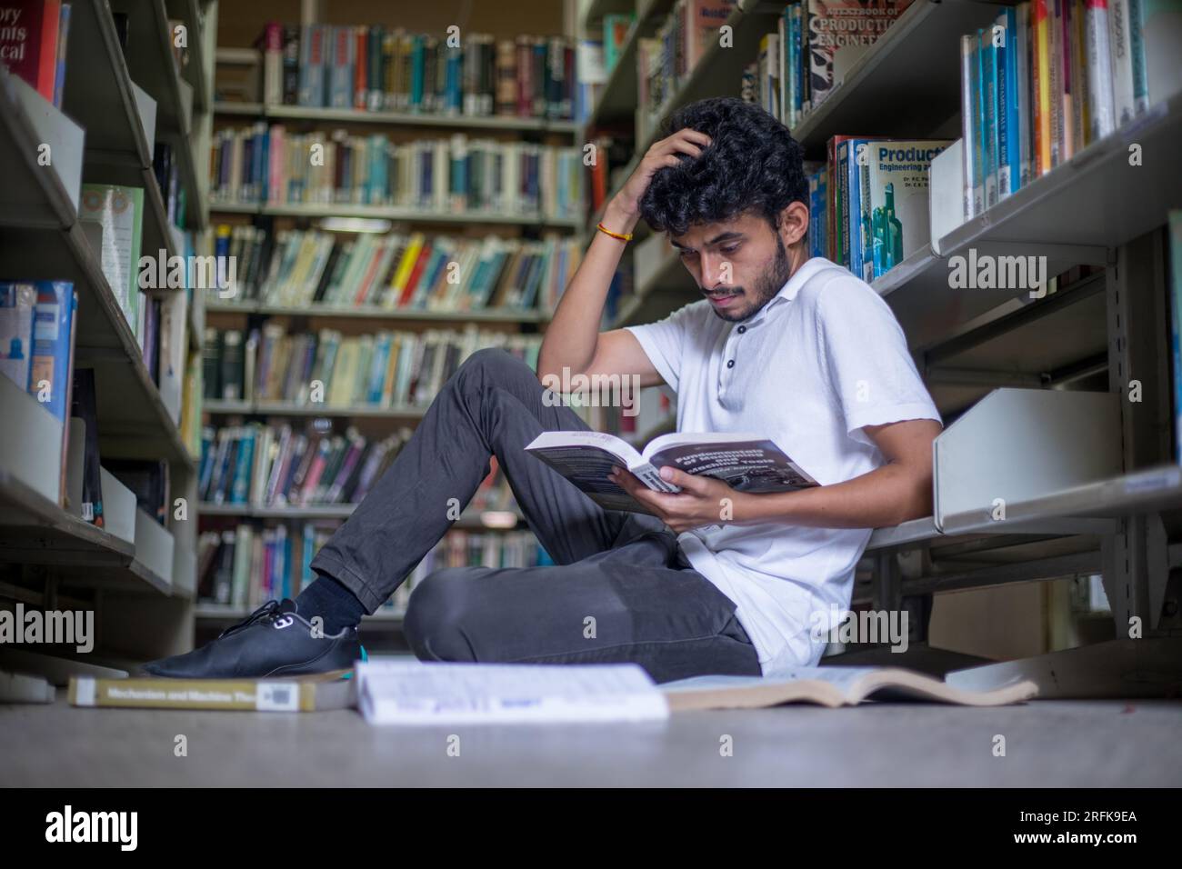 Bangalore, India- June 3, 2023: Young college student reading book time ...