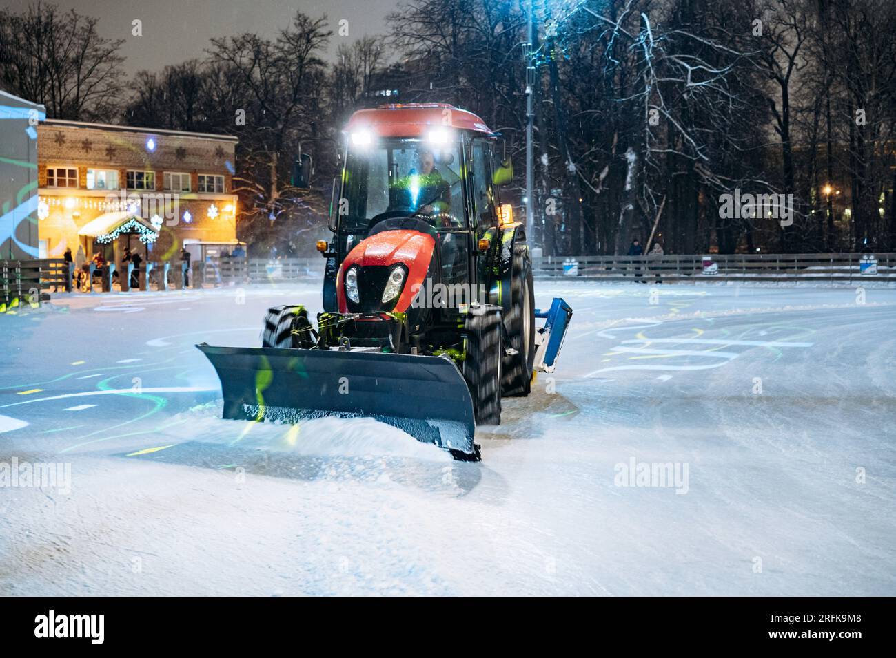 tractor cleaning ice from now on ice rink decorated and illuminated for ...