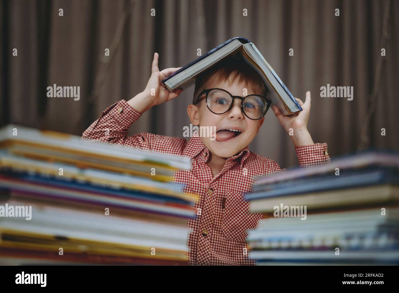 cute caucasian boy wearing glasses making funny face with tongue stuck ...