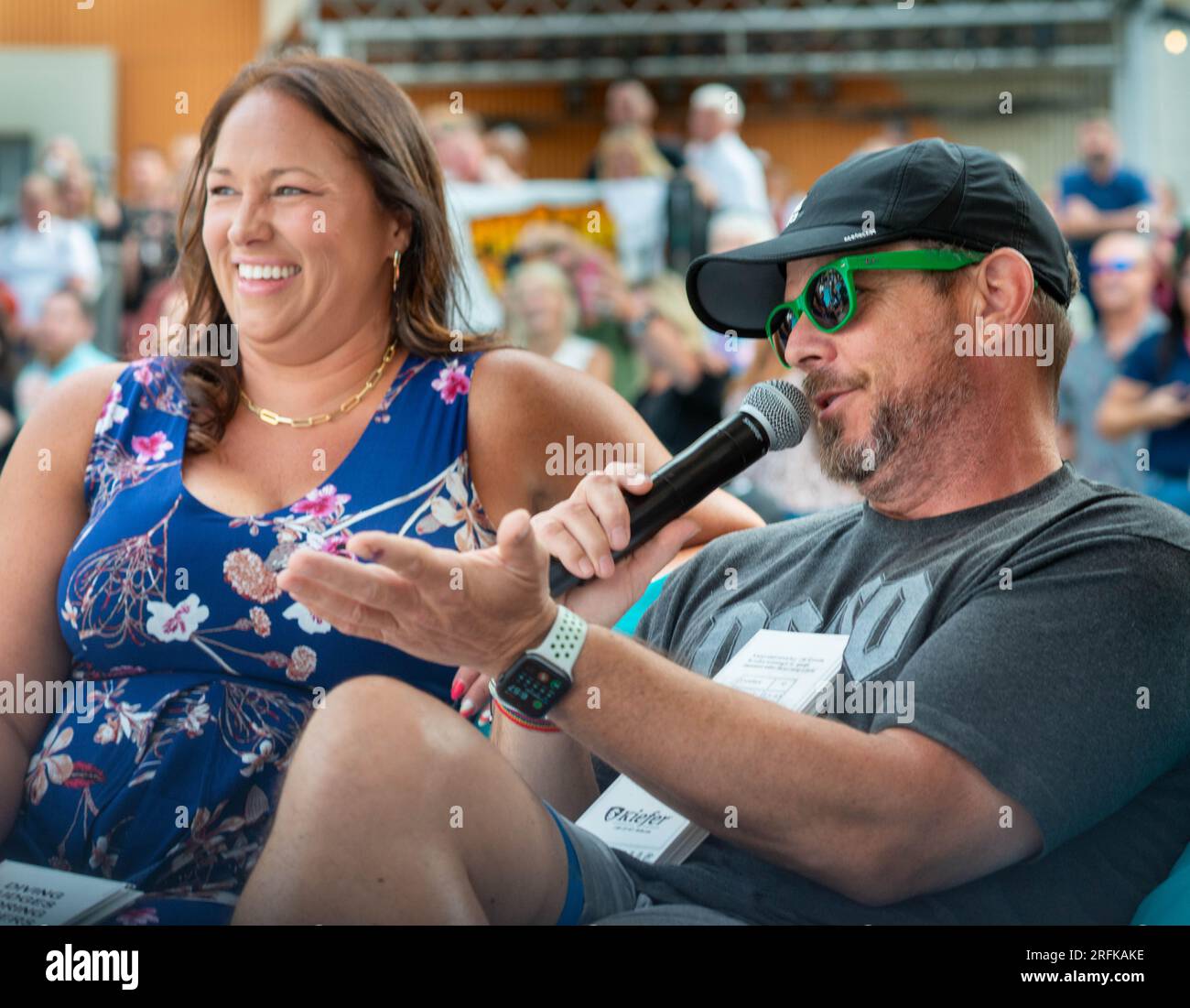 Judge Kathy Romano (left) gives her score to a contestant as fellow ...