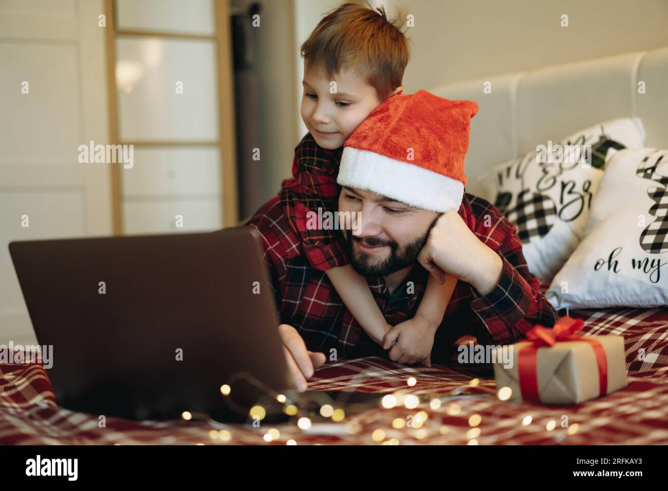 caucasian bearded handsome man in red plaid flannel shirt in santa hat ...