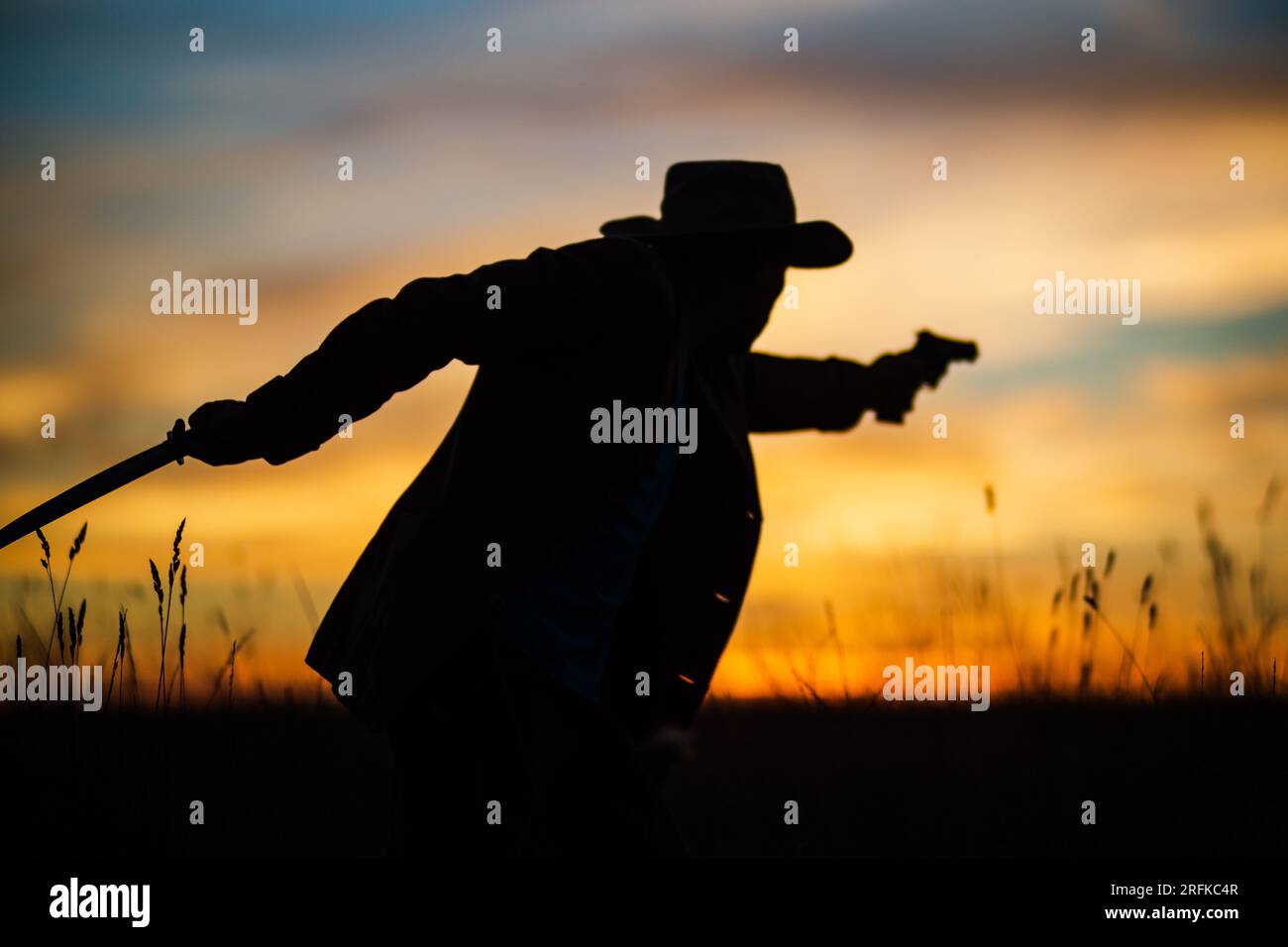 Demon and vampire hunter silhouette is fighting. A man with a katana ...