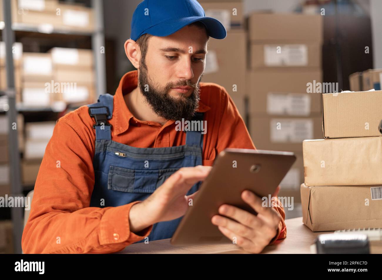 Portrait of a professional male worker uses digital tablet with ...
