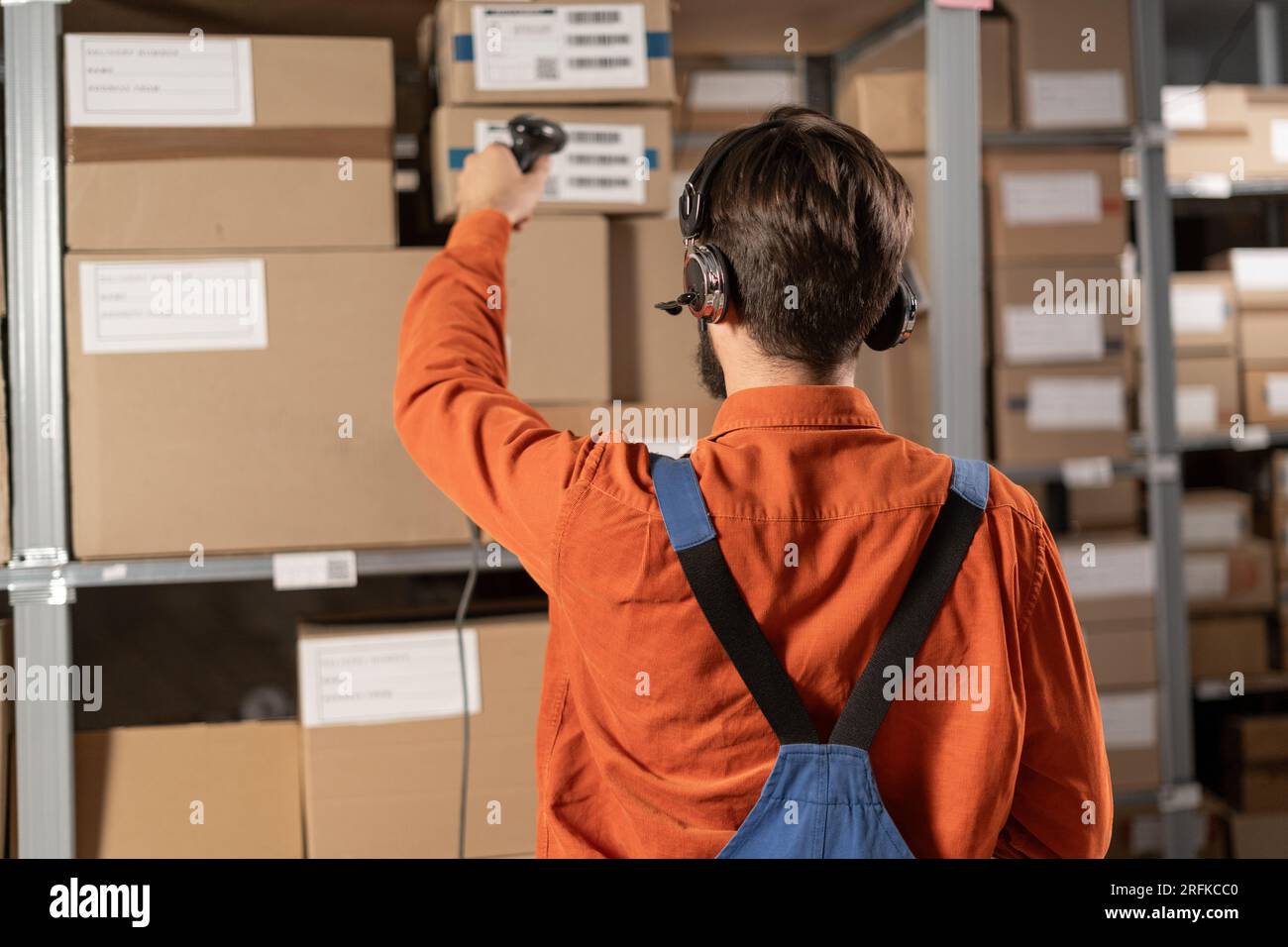 Man in headset uses a barcode reader in a distribution warehouse Stock ...