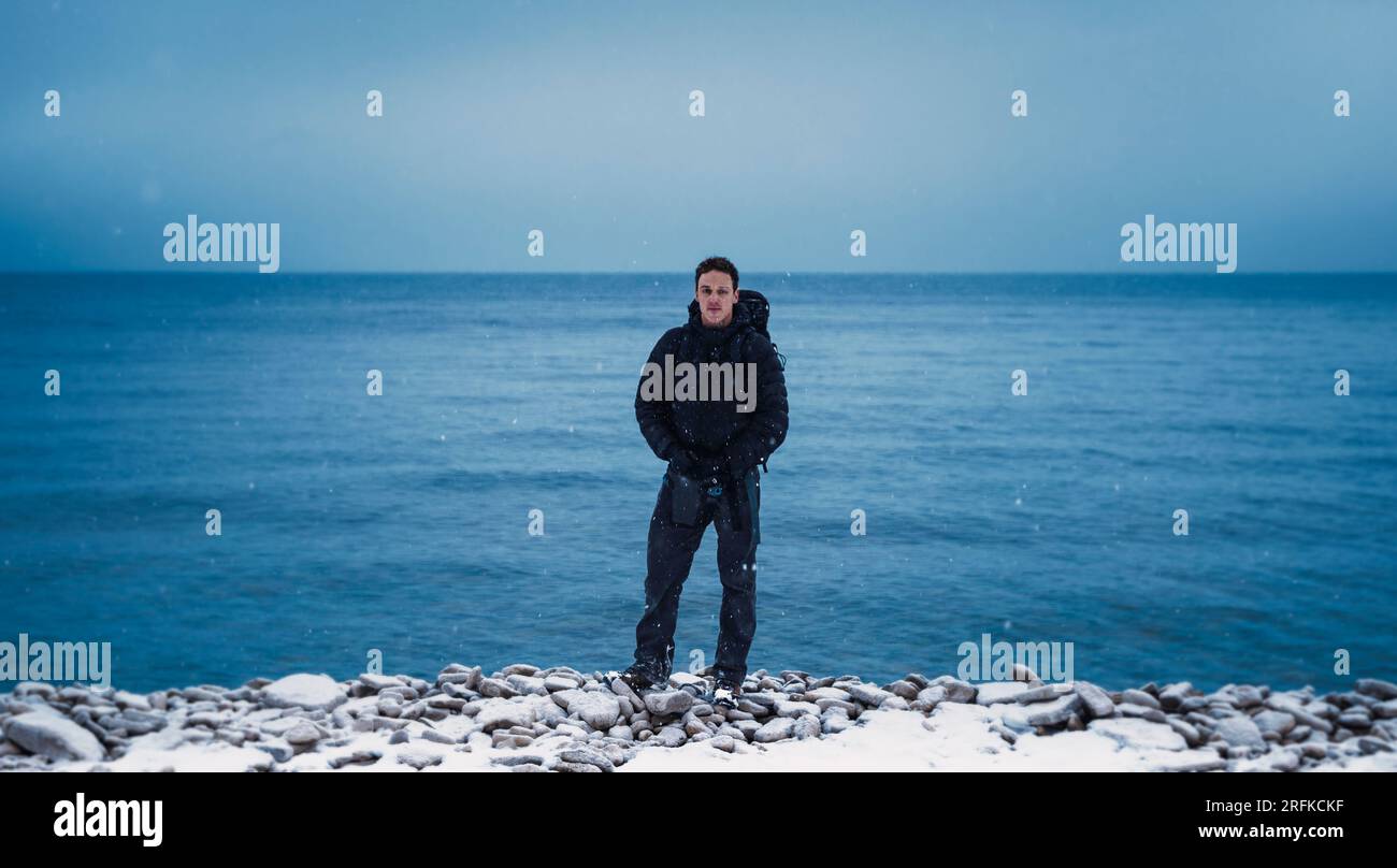 Portrait of a backpacker in front of a large body of water Stock Photo ...