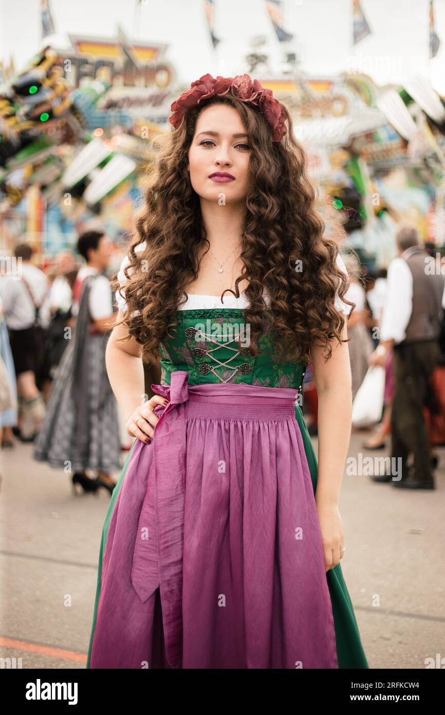 Young woman with long curly hair in Oktoberfest dress Stock Photo - Alamy