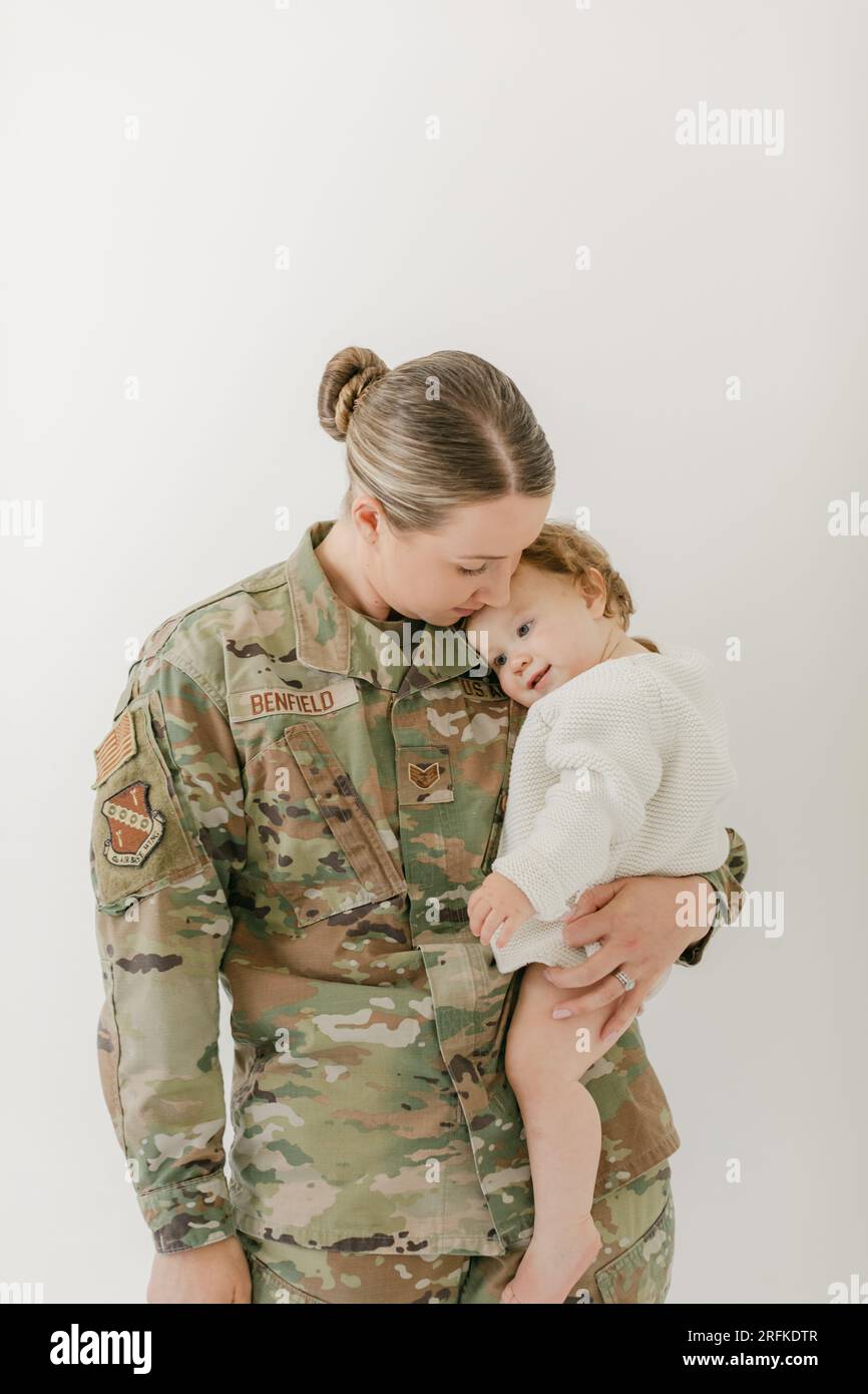 baby snuggles with active duty military mom in uniform Stock Photo - Alamy