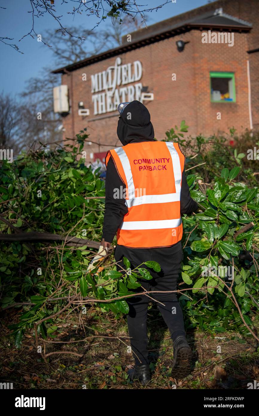 A community payback group are clearing an overgrown piece of land Stock ...