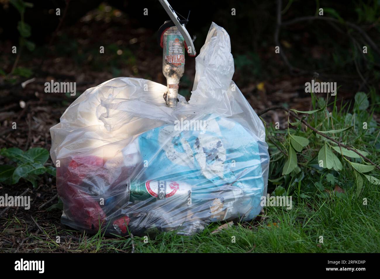 Plastic bags full of rubbish are removed from the grounds of a sports ...