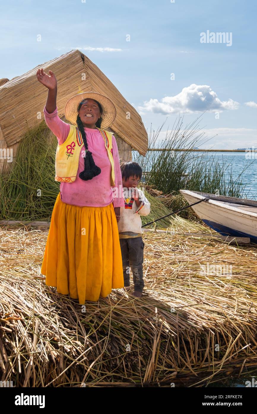 Mother and her child, belonging to the Los Uros tribe at Lake Titicaca ...