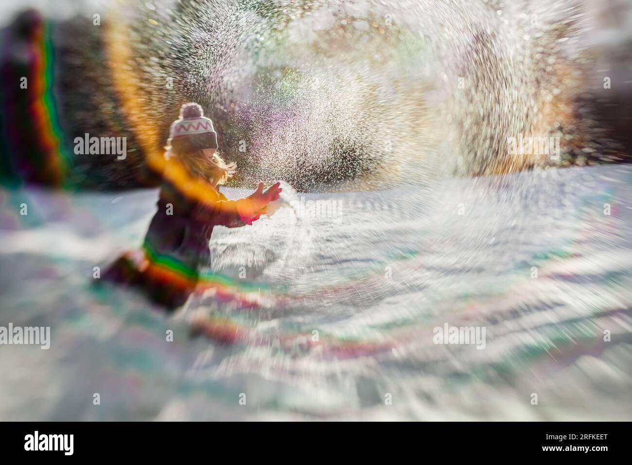 8 years old girl throwing snow in the air in a winter backyard scene ...