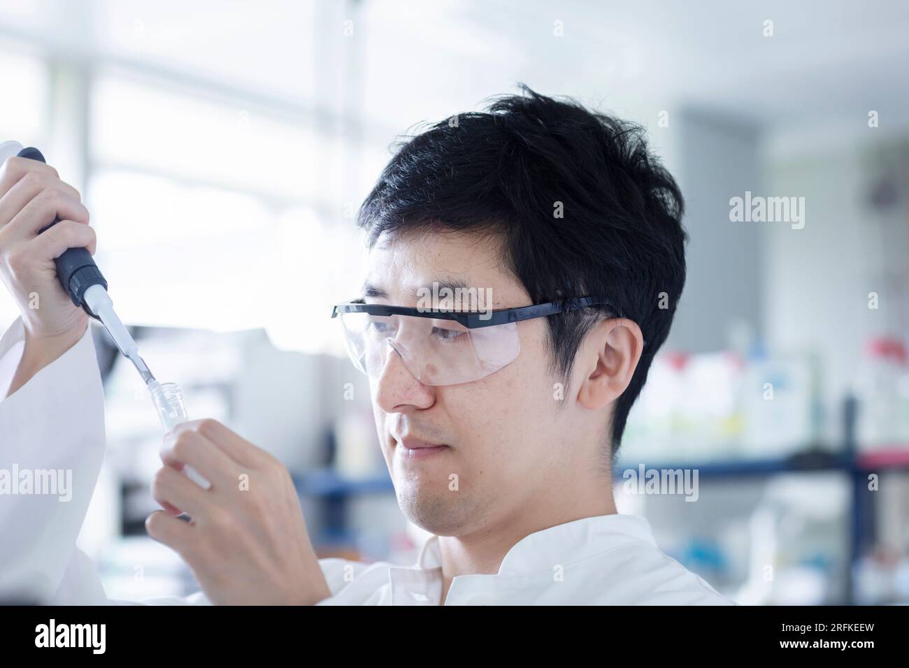 young scientist male chinese working in laboratory Stock Photo - Alamy