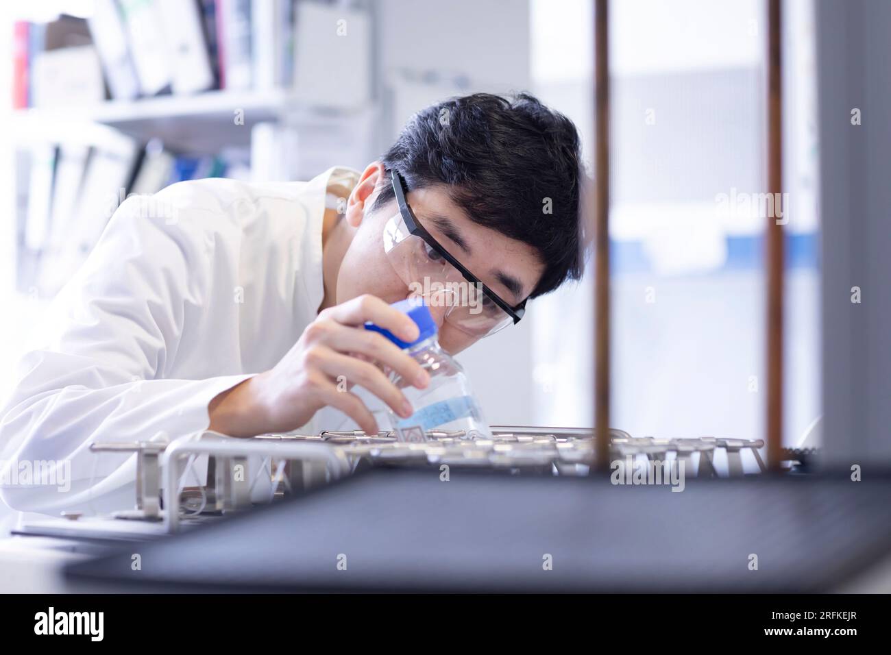 young scientist male chinese working in laboratory Stock Photo - Alamy