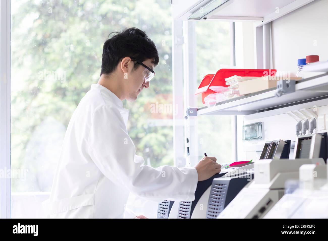 young scientist male chinese working in laboratory Stock Photo - Alamy