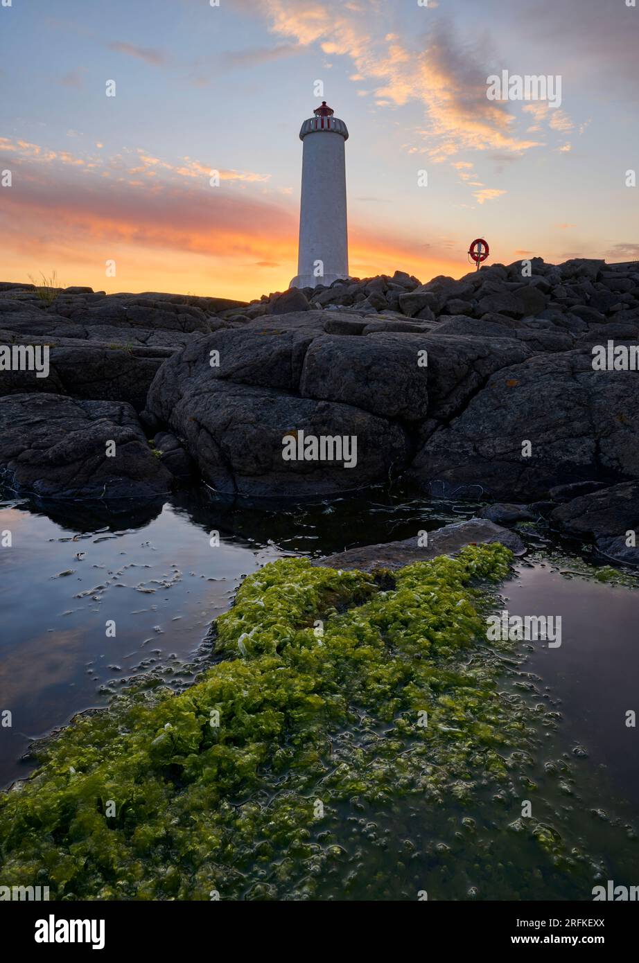 Beach on seashore under picturesque sundown sky Stock Photo - Alamy