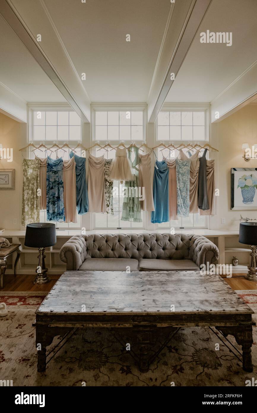 Bridesmaids dresses hanging in front of window of bridal suite Stock ...