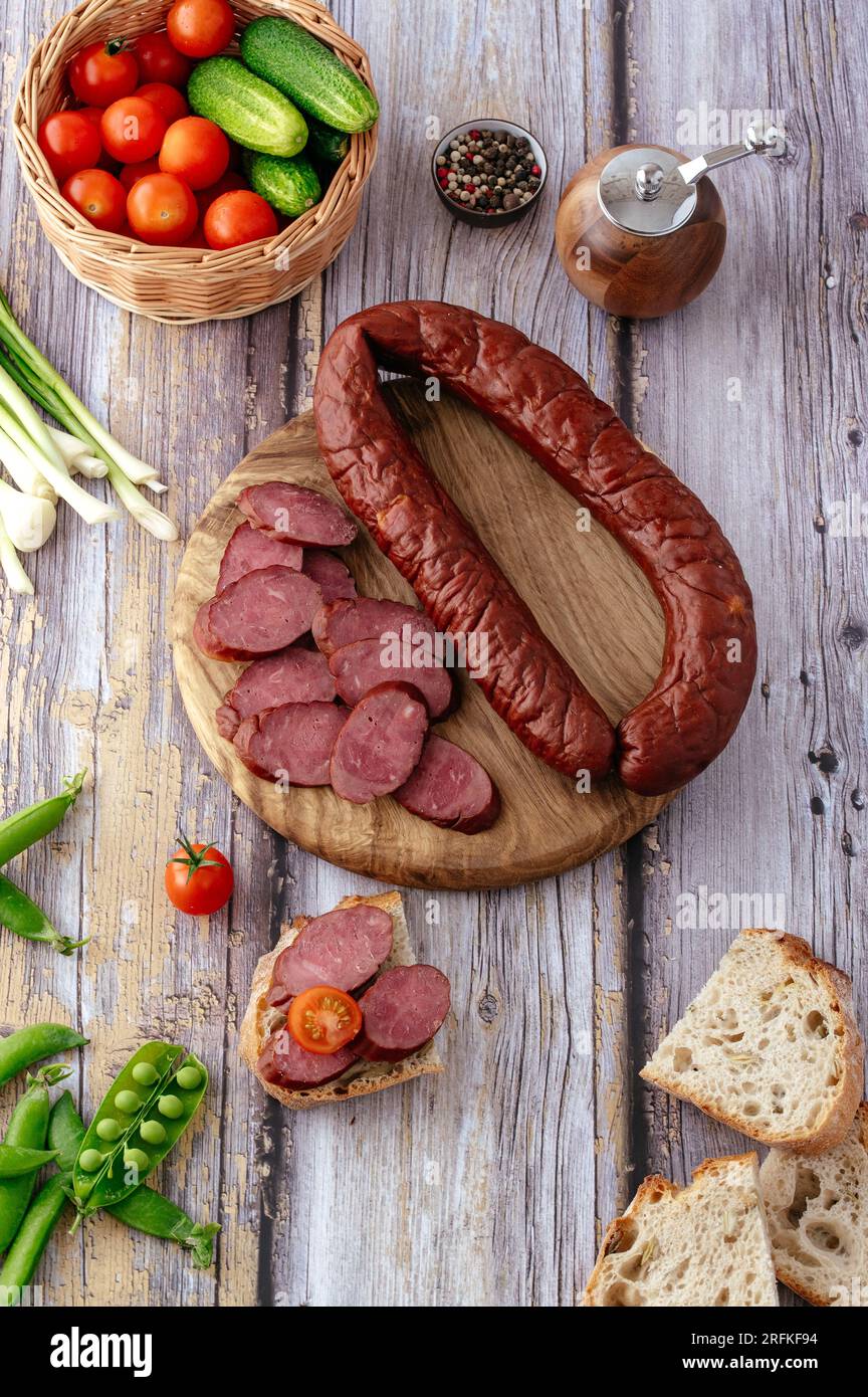 Closeup view of smoked beef sausage rings on wooden cutting boar Stock ...
