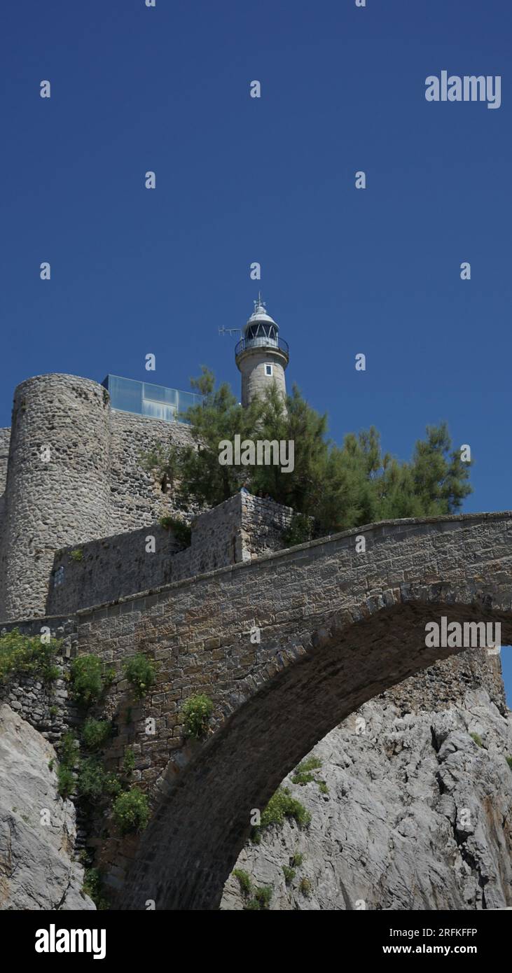 Vertical photograph of a lighthouse on the top of a mountain with a ...