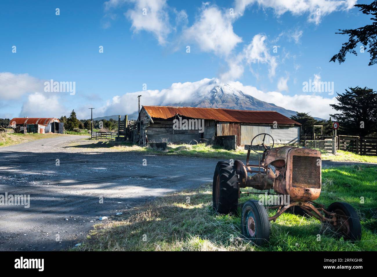 Tractor, farm buildings and Mount Taranaki, North Island, New Zealand ...