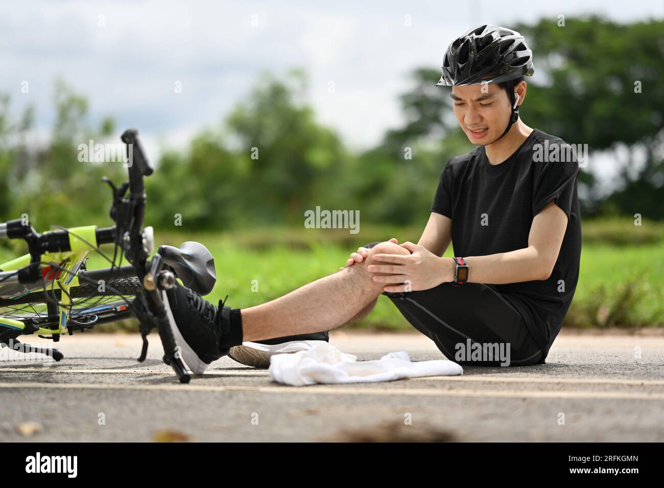 Male cyclist having an accident, falling down from bicycle and injured ...
