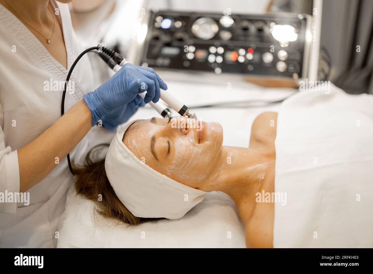 Young woman during facial microcurrent procedure Stock Photo - Alamy
