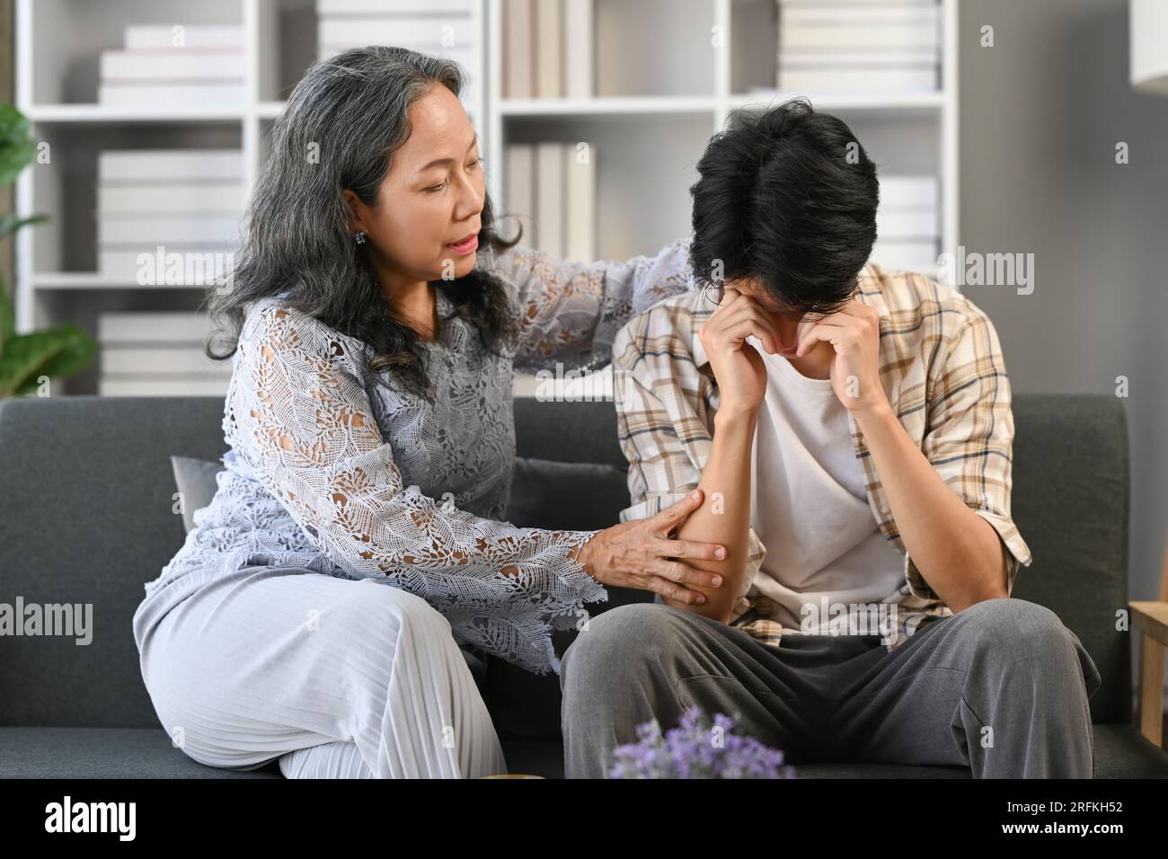 Man crying and being comforted by loving mature mother. Support, care ...