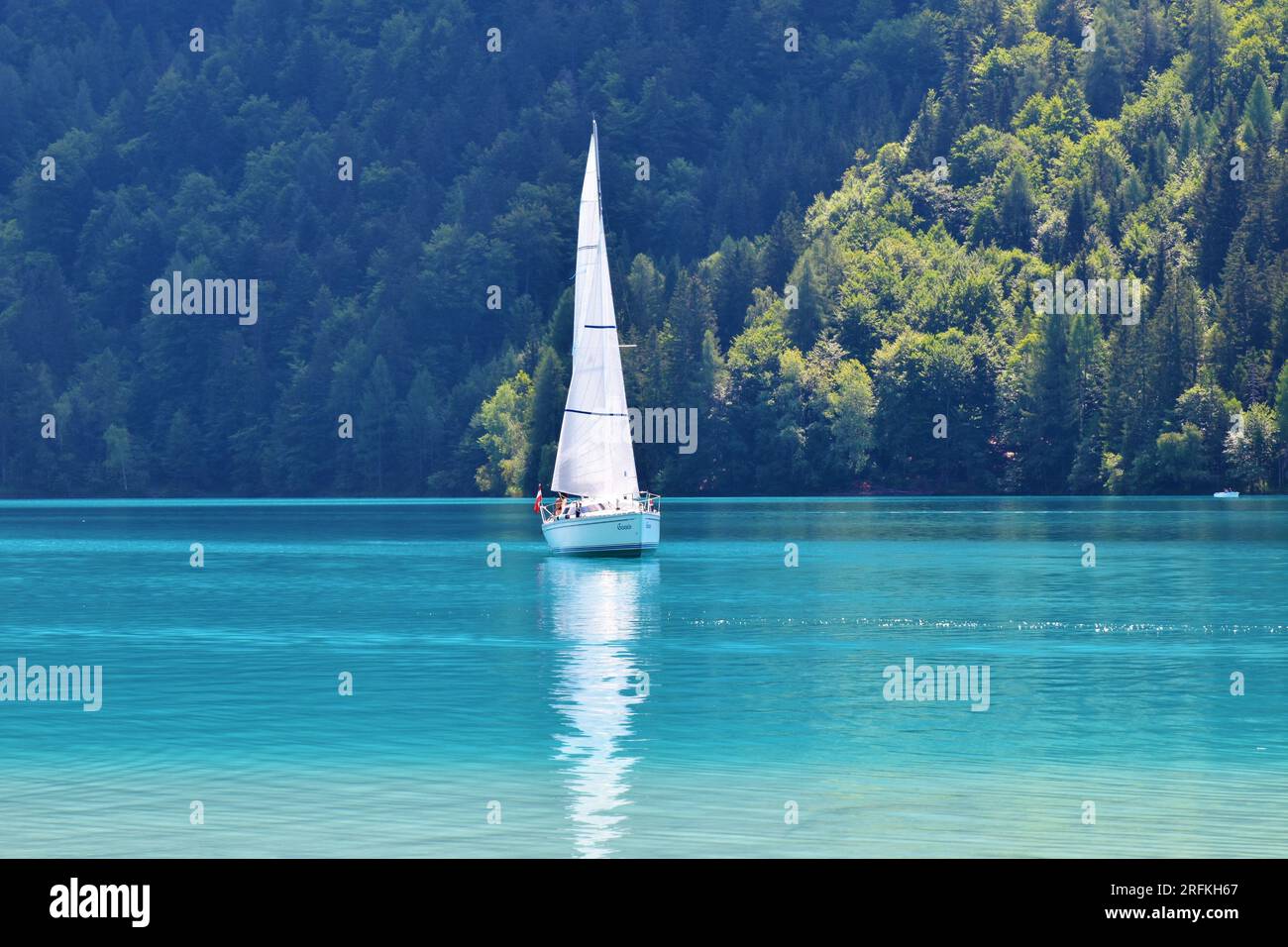 Sailboat on turquoise colored Stock Photo - Alamy