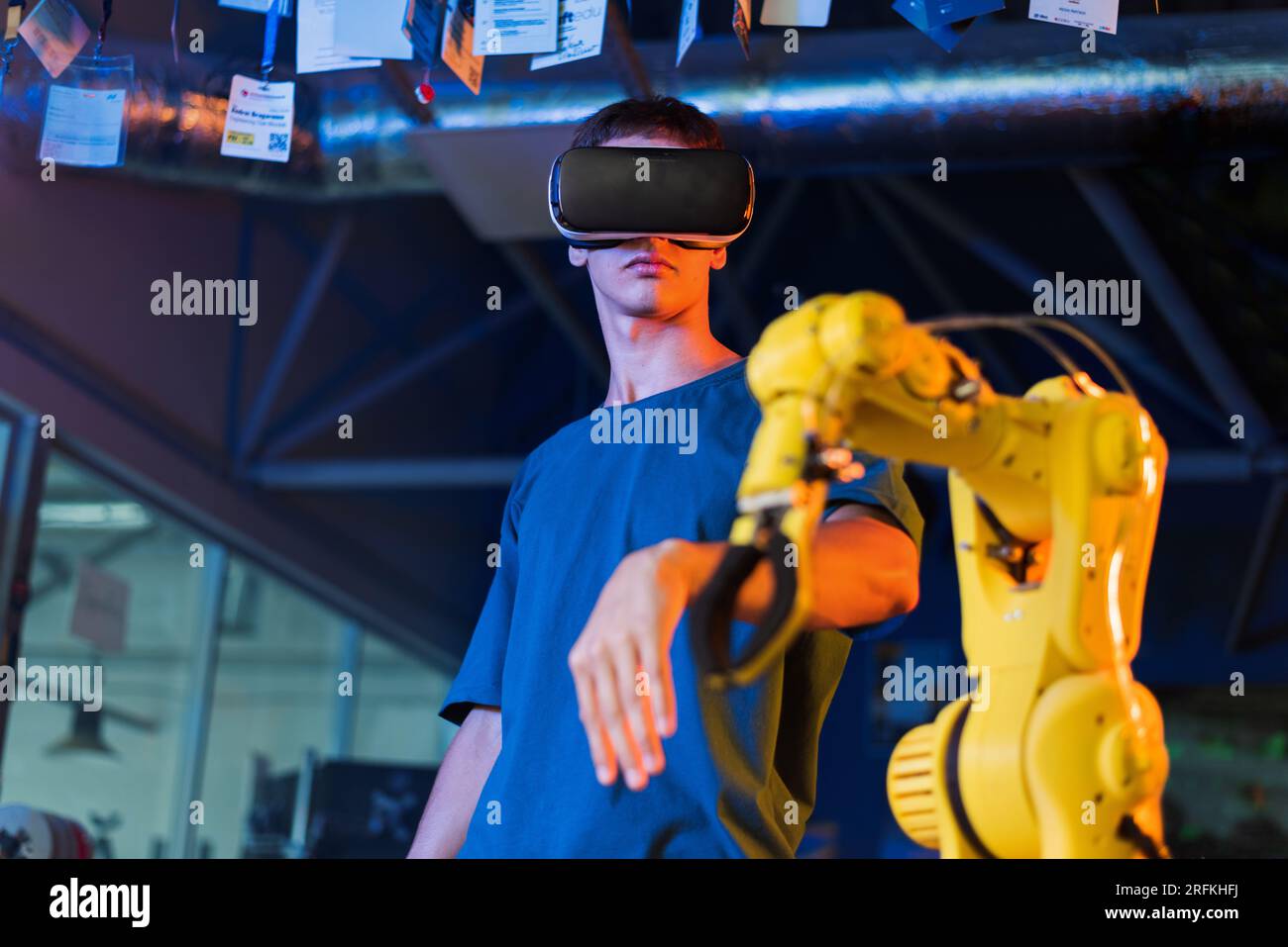 Teen doing experiments in robotics in a laboratory. Boy in VR headset ...