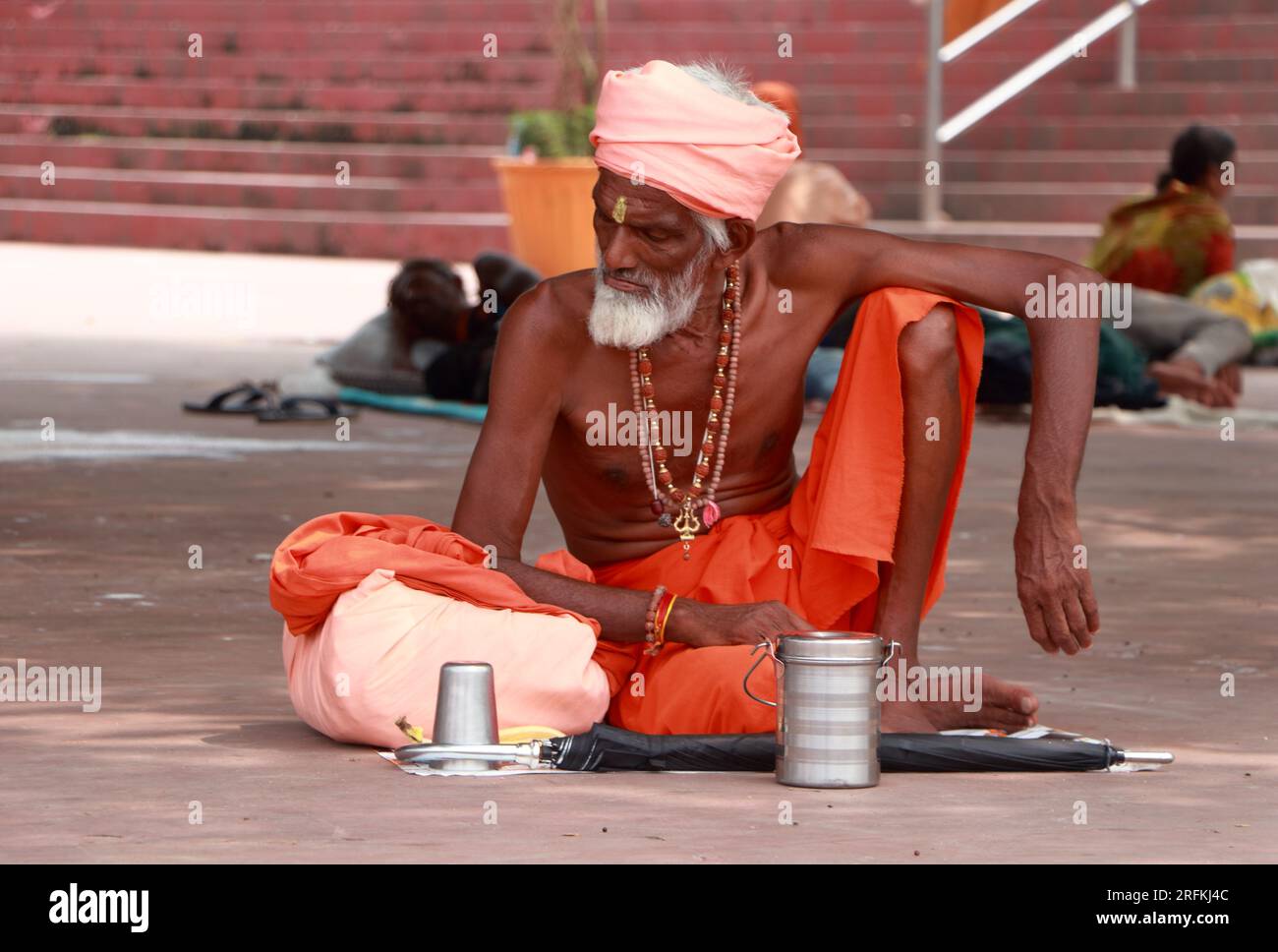 A monk sitting at the Triveni Ghat in Rishikesh Stock Photo - Alamy