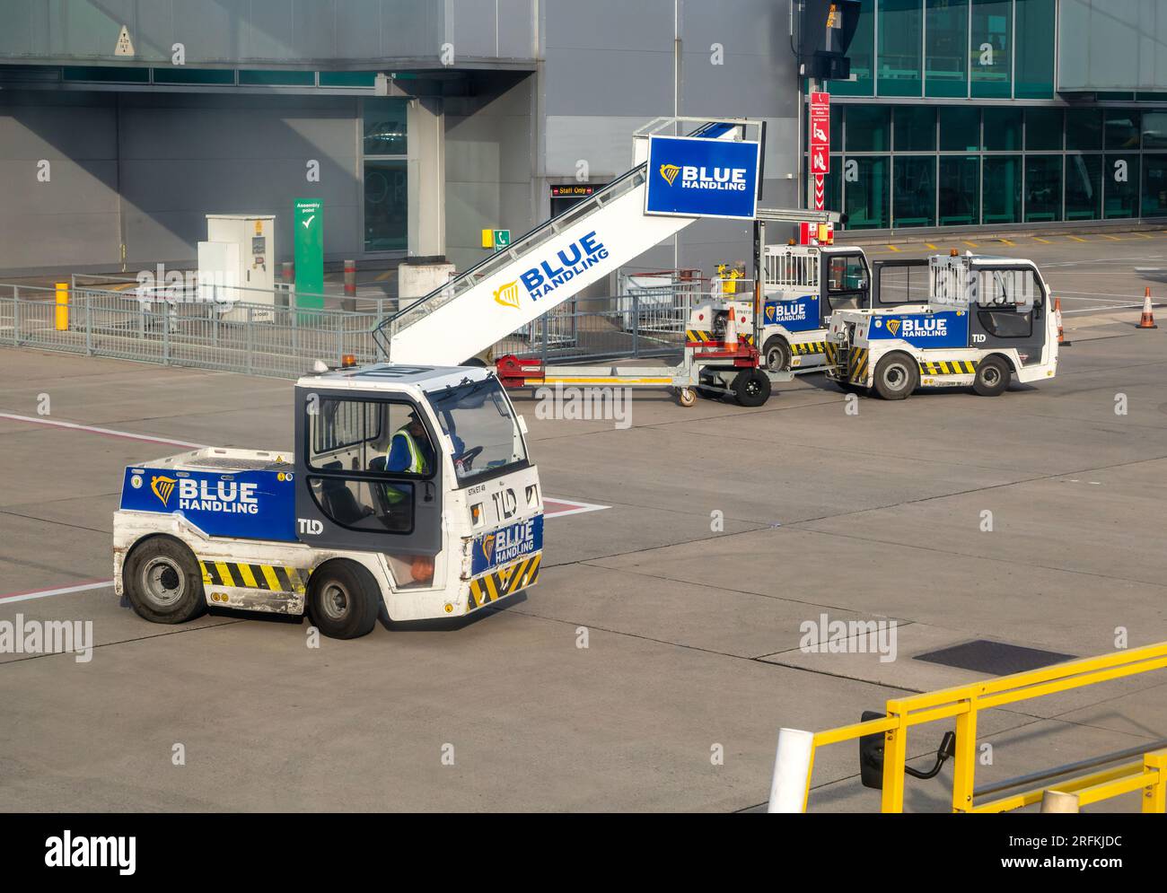 View through plane window Blue Handling aviation vehicles at London ...